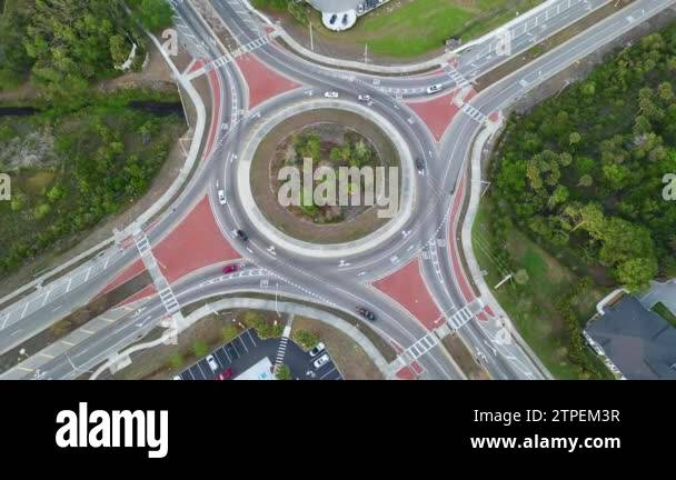 Top view of city street traffic on roundabout intersection with moving ...