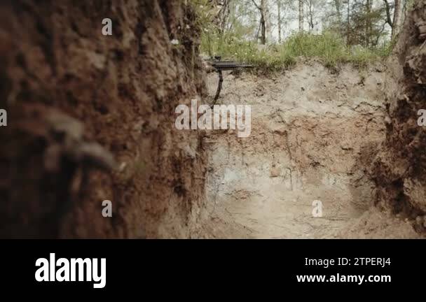 War. A soldier hides in a trench with a Kalashnikov assault rifle Stock ...