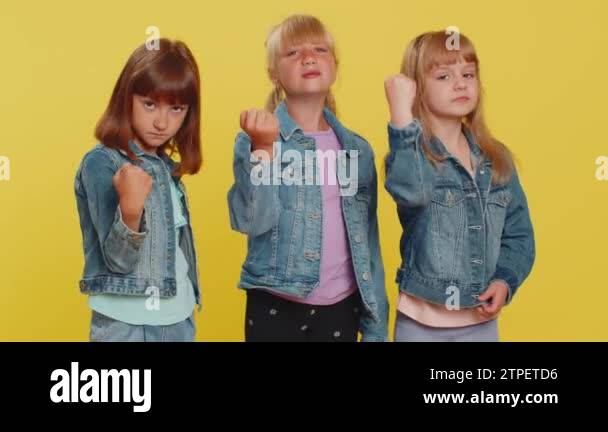 Aggressive angry teenage girls trying to fight at camera, shaking fist ...