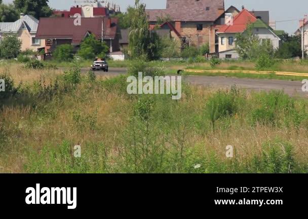 Ford Mustang Fastback with two spare wheels on roof taking part in ...