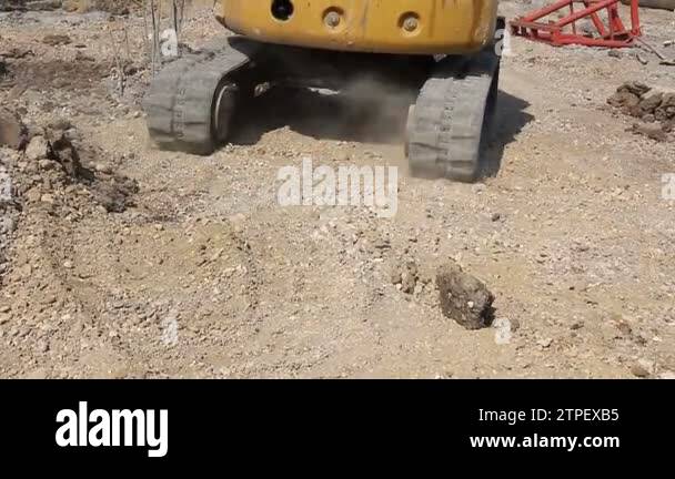 Jackhammer is breaking reinforced pillars to level them.Excavator is ...