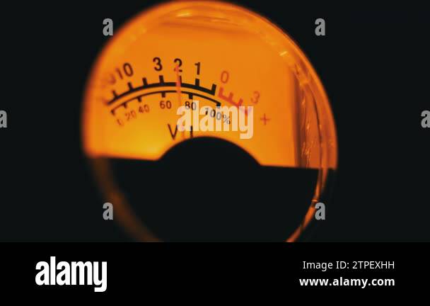 Analog dial indicator of audio signal level. Vintage arrow moves in ...
