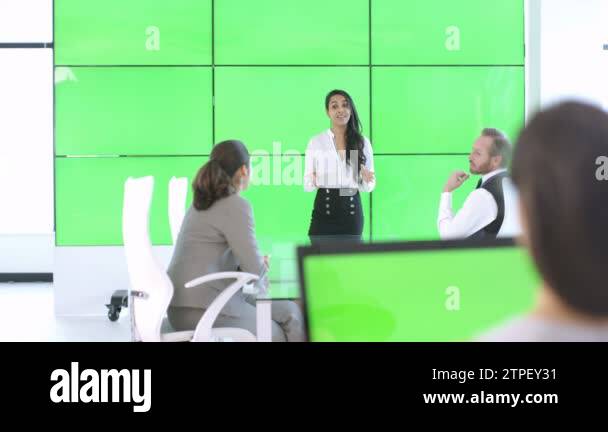4K Business team in a meeting, young woman interacting with green ...