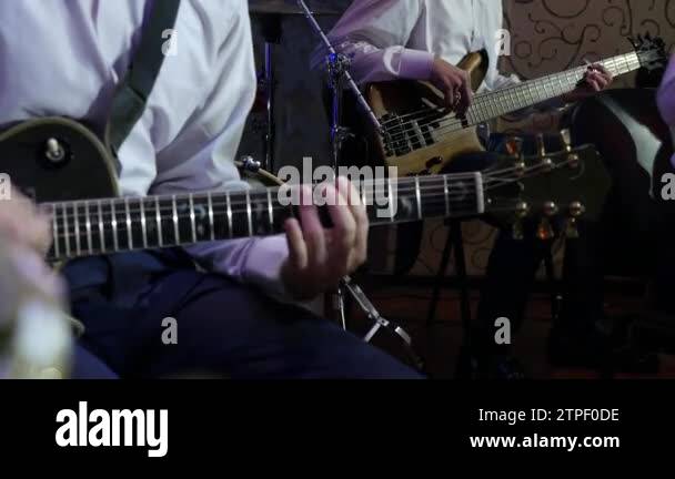 jazz band performing on stage bass guitarist in the background playing ...