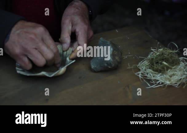 Experience ancient firecraft: skilled hands blend fungus powder in a ...