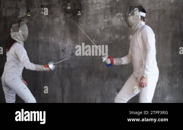 Two athletes train fencing racks in the fitness club, show the attack ...