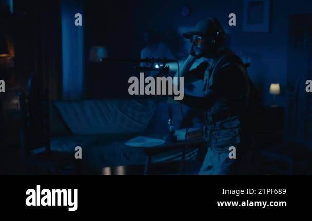 Zoom in video capturing two ghost hunters entering a dark room in ...