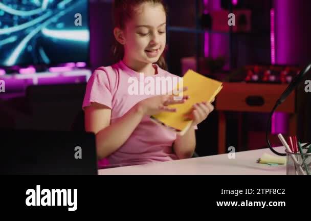 Little girl presenting her new favorite book after receiving it as ...