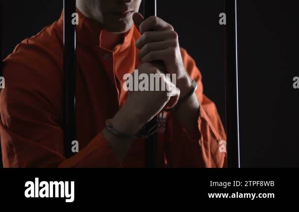 Inmate in handcuffs rubbing wrists, inhuman conditions and tortures in ...