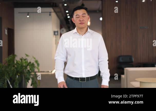 Portrait of joyful team leader posing on camera on office background ...