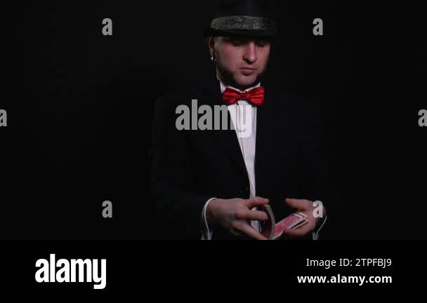Young magician shows magic playing card trick show concept trick on ...