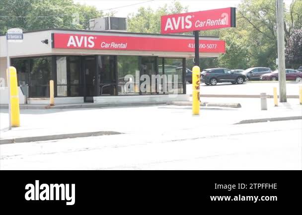 avis car rental store business company front entrance on bright day ...