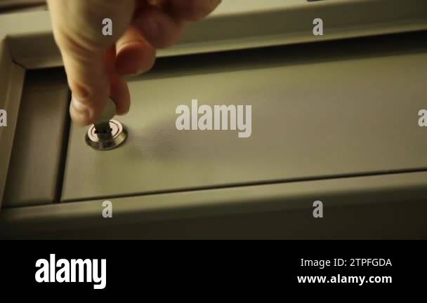 Key unlocked a safe latch and opening door safety deposit box. man ...