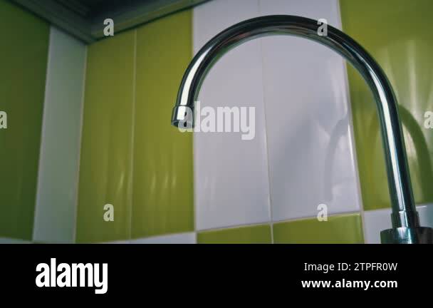 Close-up of water flowing from a kitchen faucet. drinking water from ...