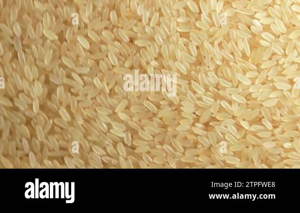 Dry Uncooked Parboiled Rice Background Rotating Clockwise - Top View ...