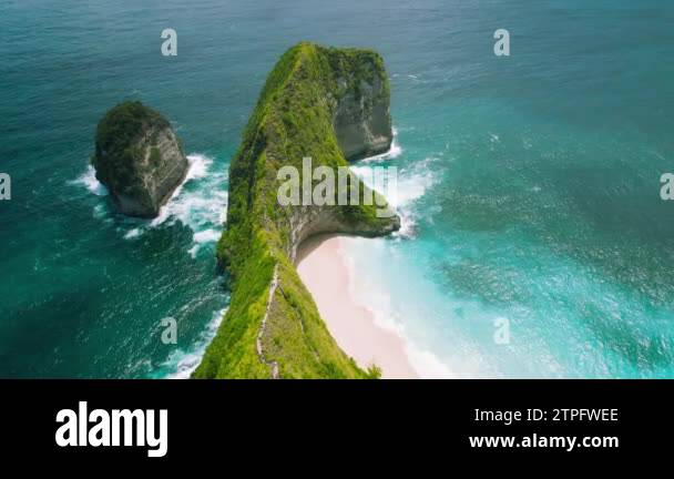 Tropical pristine sandy beach and green forest on ocean coastline with ...