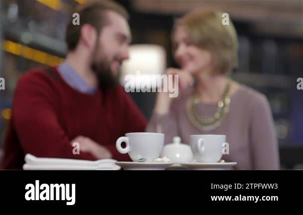 Two young people in cafe enjoying the time spending with each other ...