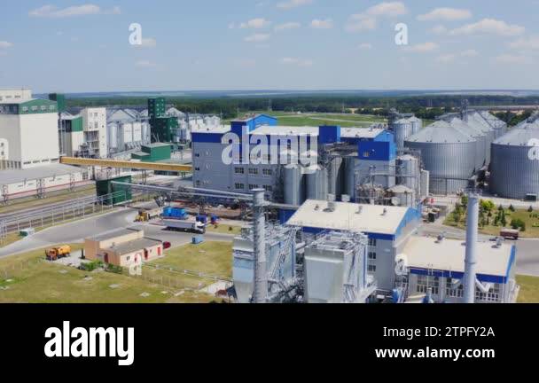 Grain elevators on nature background. Granary on a modern territory ...