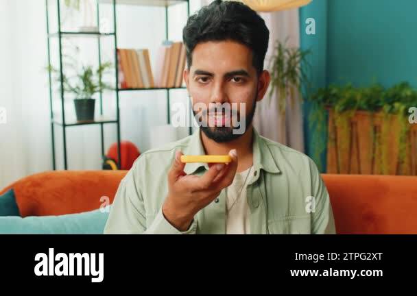 Happy excited Indian man making phone call conversation with friends at ...