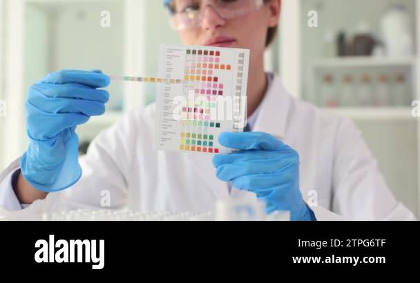 Laboratory worker checks patient test results looking at color palette ...