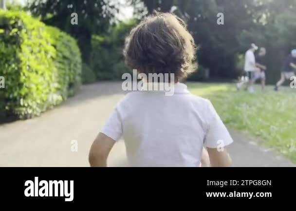 Boy Runs Ahead of Mother in Sunlit Park - Authentic Motherhood Scenes ...