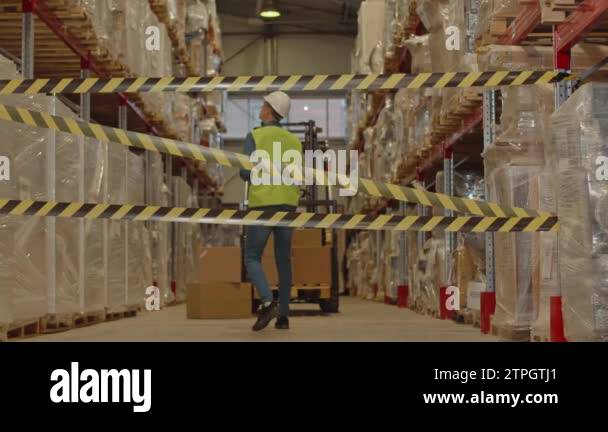Full length back view of male worker in safety uniform and hard hat ...