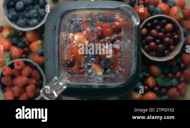 Berries inside blender with water seen from top-view overhead ...