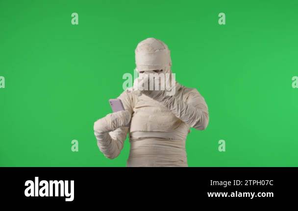 Green screen isolated chroma key video of a mummy typing on a ...