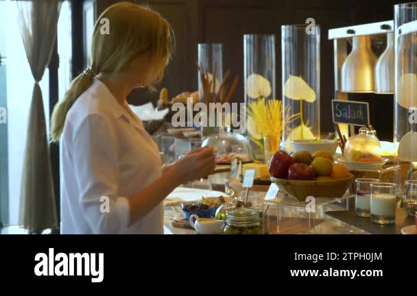 Self service took the food from the buffet line. the woman is preparing ...