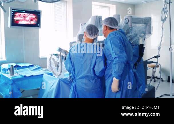 Operation with futuristic equipment. Backside view of two doctors ...
