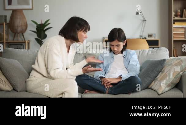Mother raises voice in anger toward son, who responds by covering ears ...