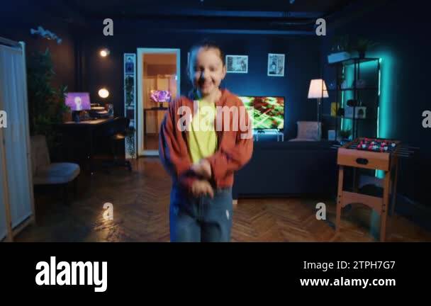 Cute kid pressing record button on filming equipment, doing dance ...