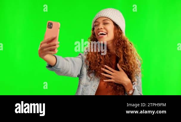 Happy woman, goofy face and selfie on green screen with silly facial expression against a studio ...