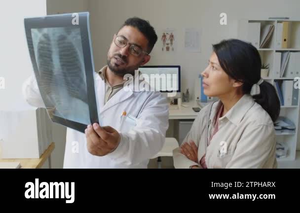 Waist up of Middle Eastern male radiology specialist examining lung x ...