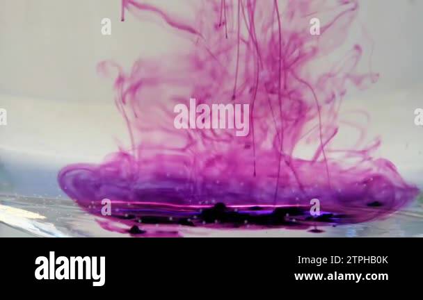 Purple crystals of potassium permanganate dissolve in the whirlpool of ...