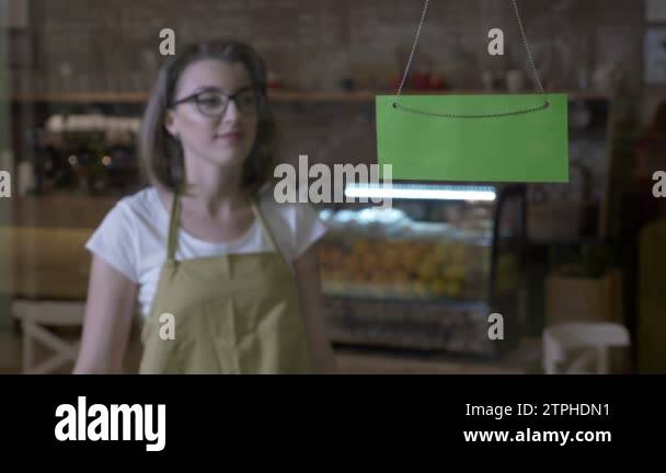 Young worker cafe shop girl flipping over open close green screen sign ...