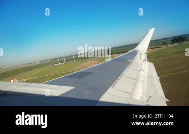 Aircraft wing window view while airplane taking off from airport Stock ...