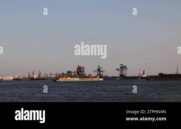 Ships float across the North Sea. Windmills in the background. Slow ...
