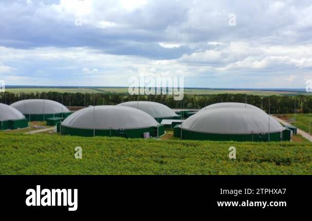 Biogas production. Huge storage tanks for biomass on green field ...