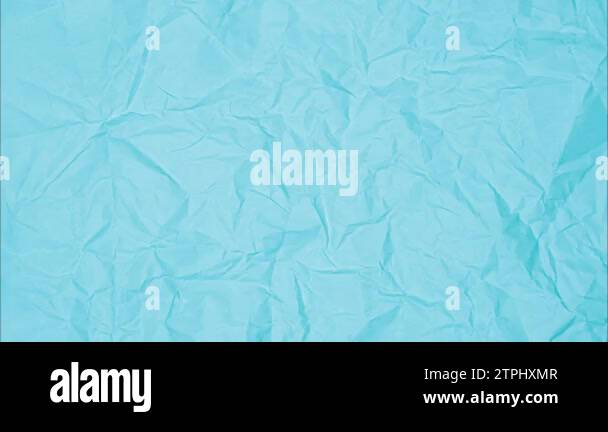Video Top view of wrinkled textured light blue paper. Blue crumpled ...