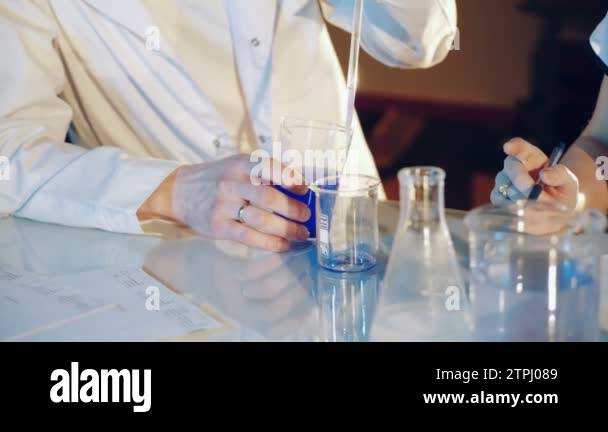 Scientist conducts experiments with chemical reagents. Process of ...
