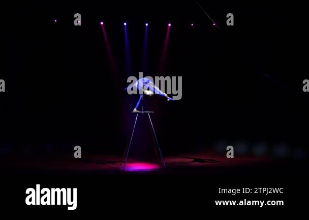 Flexible beautiful slim gymnast artist performing on the stage. 4K ...