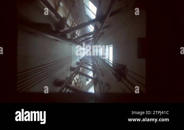 shot through the bottom of a glass elevator whilst the elevator is ...