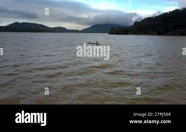 pictorial upper view motion past man riding dugout canoe with stick on ...