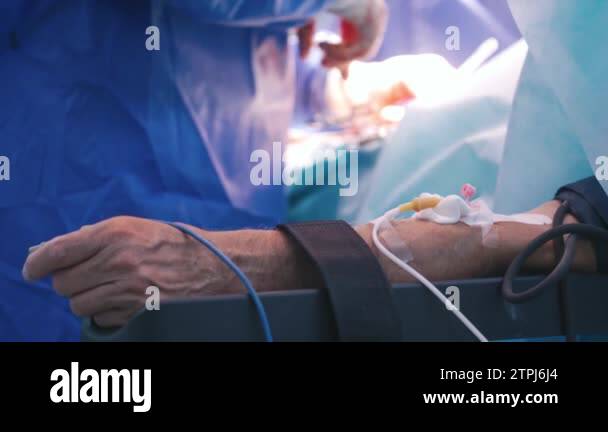 Surgery operation. Human hand with bandage and medical pipes on the ...