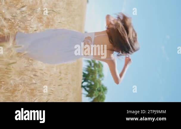 Joyful lady running spikelets sunshine nature back view. Vertical ...