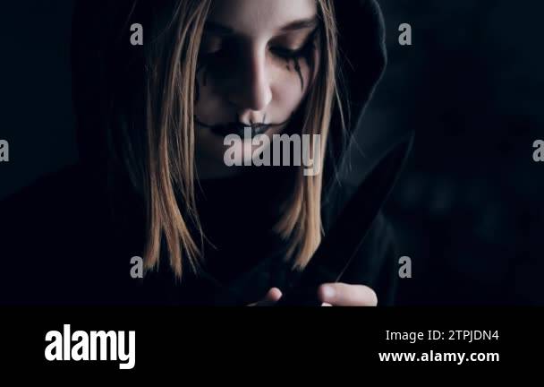 Spooky preteen girl holding knife and looking at camera. Scary child ...