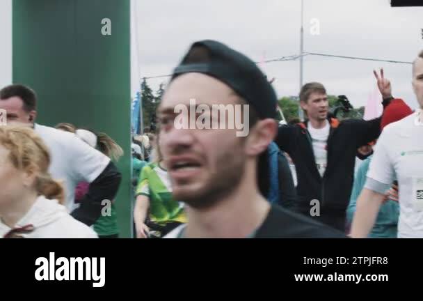 Exhausted people crowd relax walking after marathon finish line Stock ...