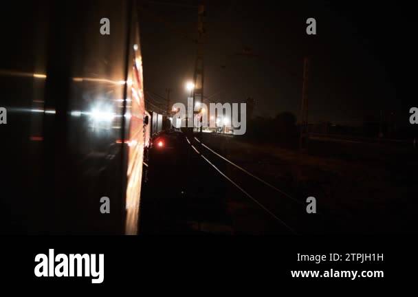 Real time view of goods train with reflecting rakes moving slowly and ...