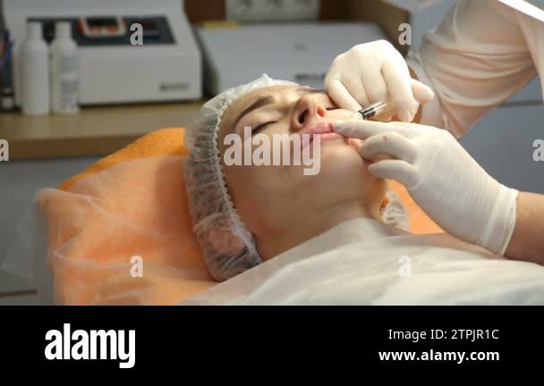 Beauty clinic. Beautician hands in gloves making face aging injection ...